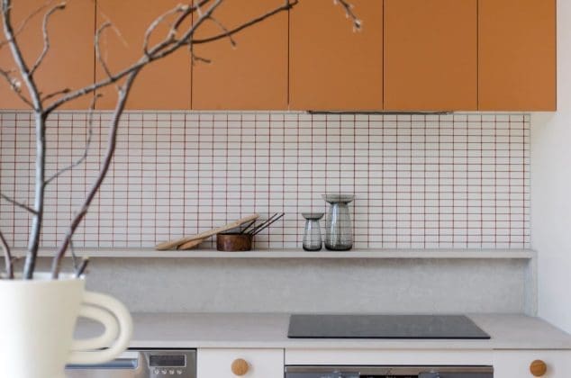 Evergreen: The orange kitchen with coloured joinery and grout