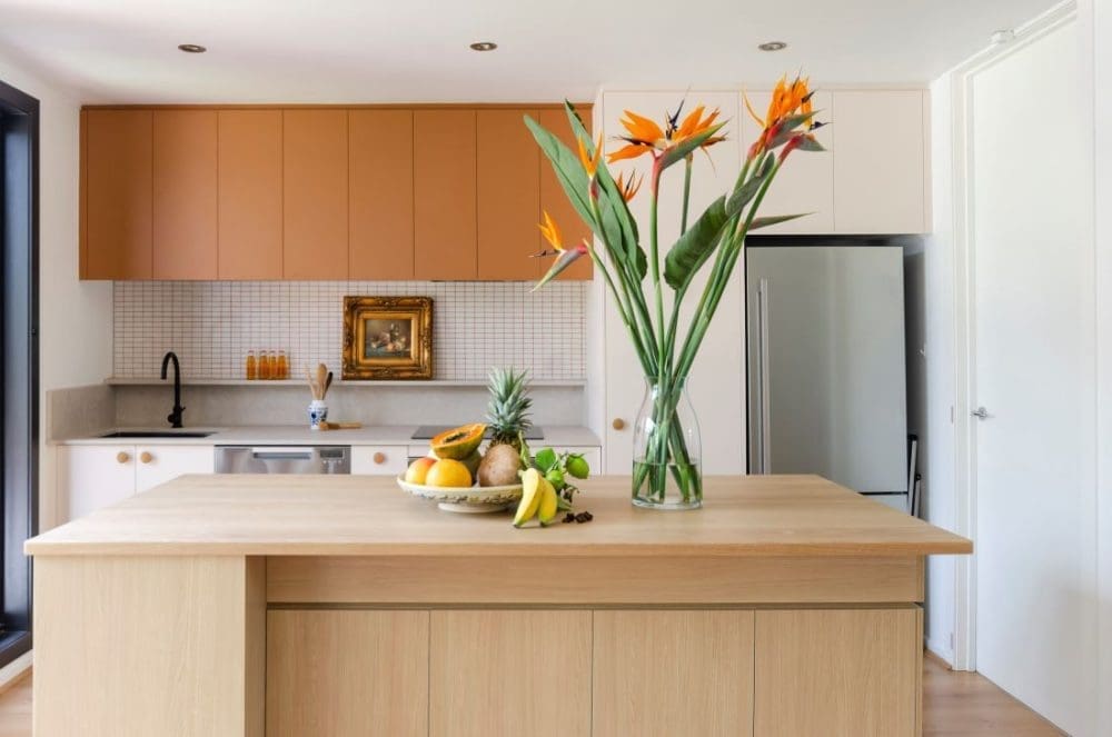 Evergreen: The orange kitchen with coloured joinery and grout