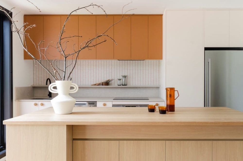 Evergreen: The orange kitchen with coloured joinery and grout