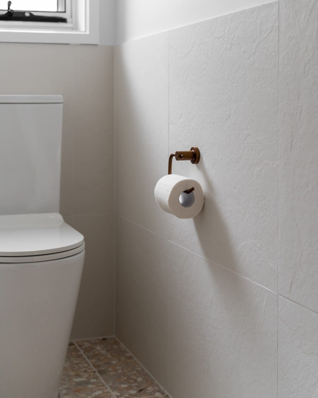 Peachy terrazzo floor tiles and brushed bronze tapware bathroom | Style ...